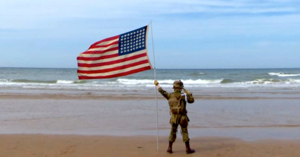 Little Boy Holds Flag For One Hour In Memory Of Fallen Soldiers Of D-Day